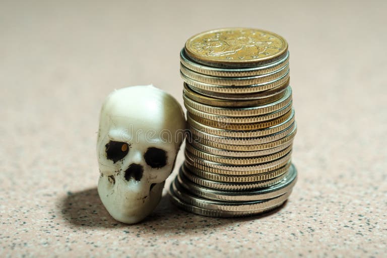 Skull from the Human Skeleton and a Stack of Coins Stock Photo - Image ...