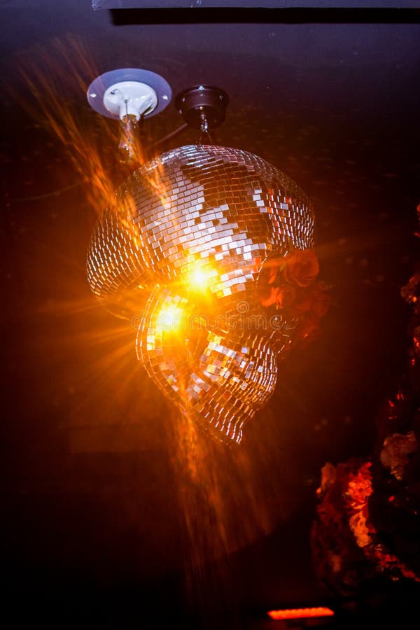 Skull Shaped Disco Ball with Orange Light Reflecting from it Stock ...