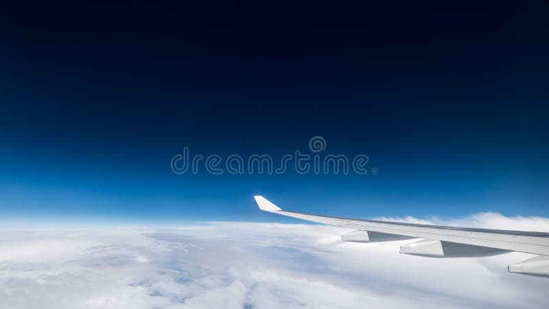 Travel Image of Deep Blue Sky, Clouds and Wing View Outside Aircraft ...