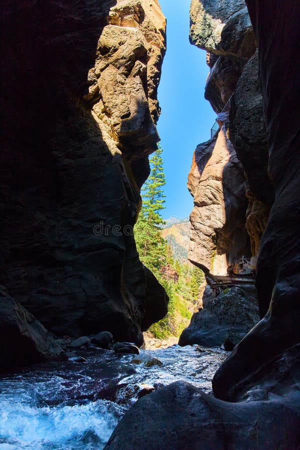 Sky through Deep Gorge with River Flowing and Old Mining Equipment ...