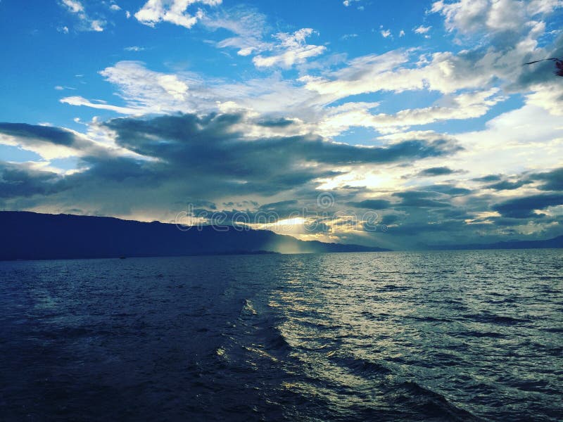 Sky light into the ocean stock photo. Image of wave - 224173982