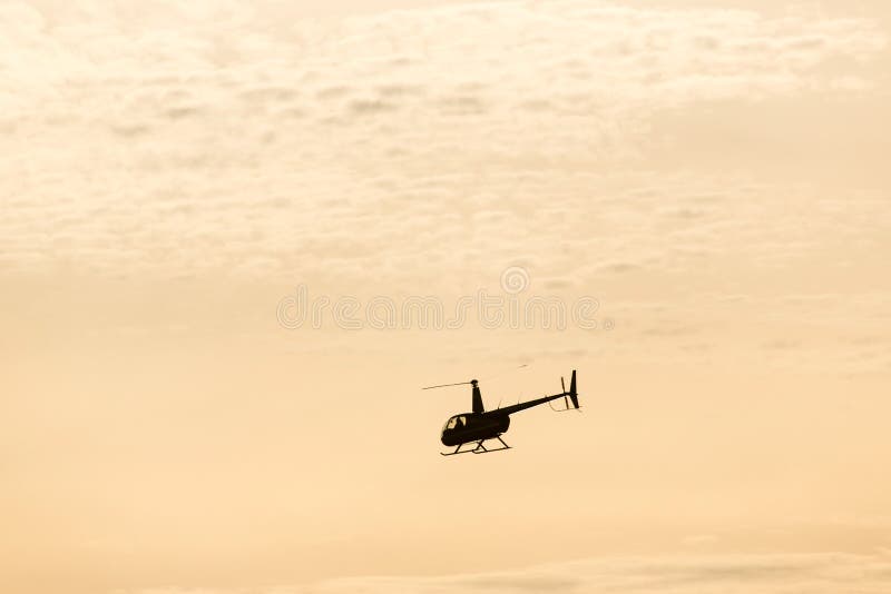 Helicopter at sunset stock photo. Image of flight, sunlight - 243497454