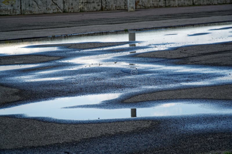 View Of Street Pavement Wet After Rain With Water Puddles Stock Photo ...
