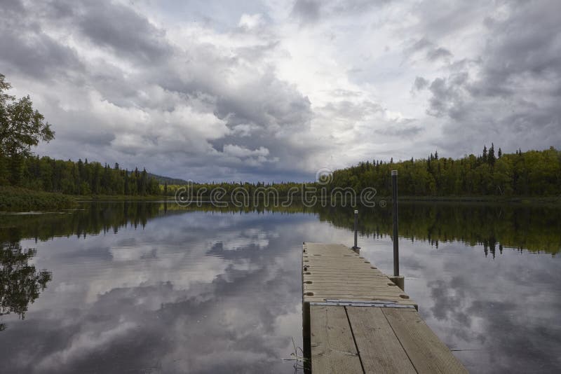 Sky Reflection in Alaskan Lake Stock Photo - Image of pier, clouds ...