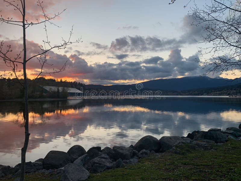 The Sky Reflects in the Calm Water of this Lake As the Sun Sets Stock ...