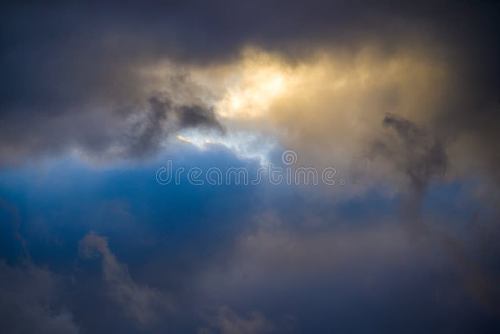 Sunlight Breaking through Multicolored Dark Storm Clouds Stock Photo ...