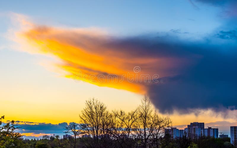 Sunlit Colored Rain Cloud in Blue Sky Over City at Sunset Stock Image ...