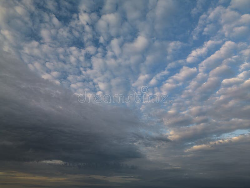 The Sky with Streaks of Cumulus Clouds, with Gray Clouds Rolling in. Stock Photo - Image of ...