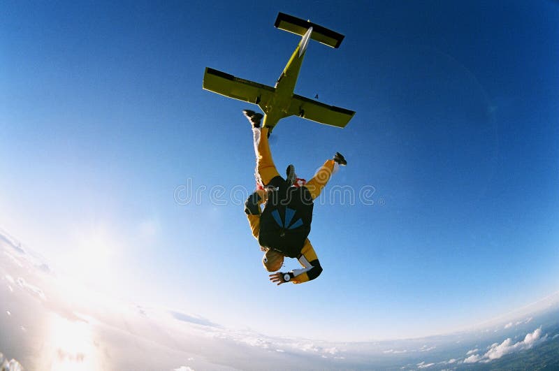 Skydiver Parachuting Down To the Earth. Stock Photo - Image of ...