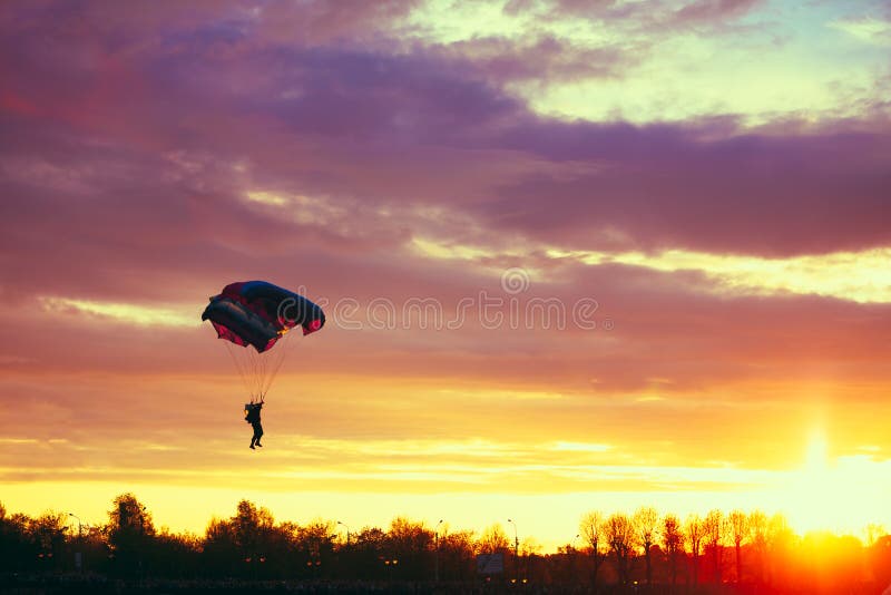 Skydiver on Colorful Parachute in Sunny Sunset Stock Photo - Image of ...