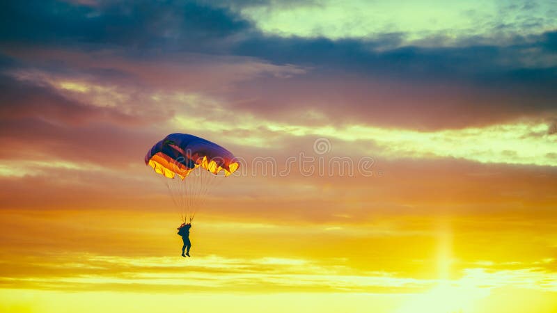 Skydiver on Colorful Parachute in Sunny Sunset Sky Stock Image - Image ...