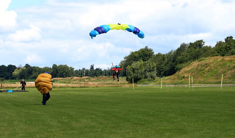 Skydiver Parachuting Down To the Earth. Stock Photo - Image of ...