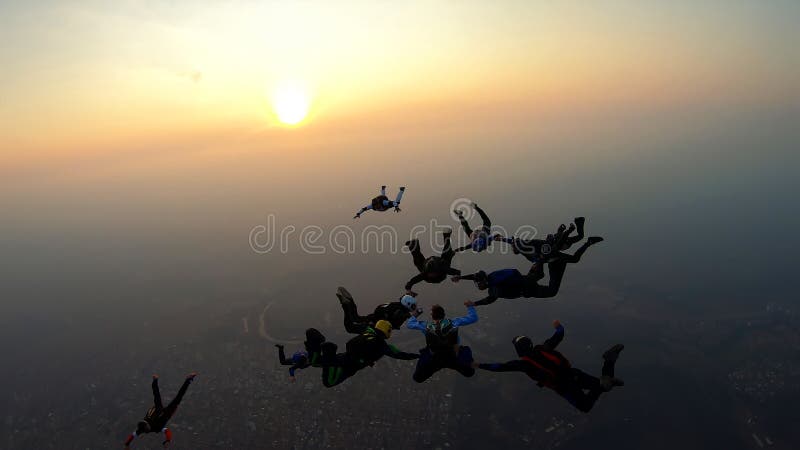 Silhouette of a Group of Skydivers Jumping at the End of the Day. Stock ...