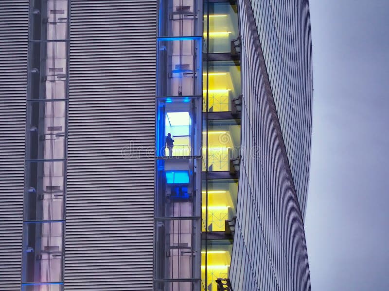 Skyscraper External Elevator with Persons Silhouette Inside Stock Image ...