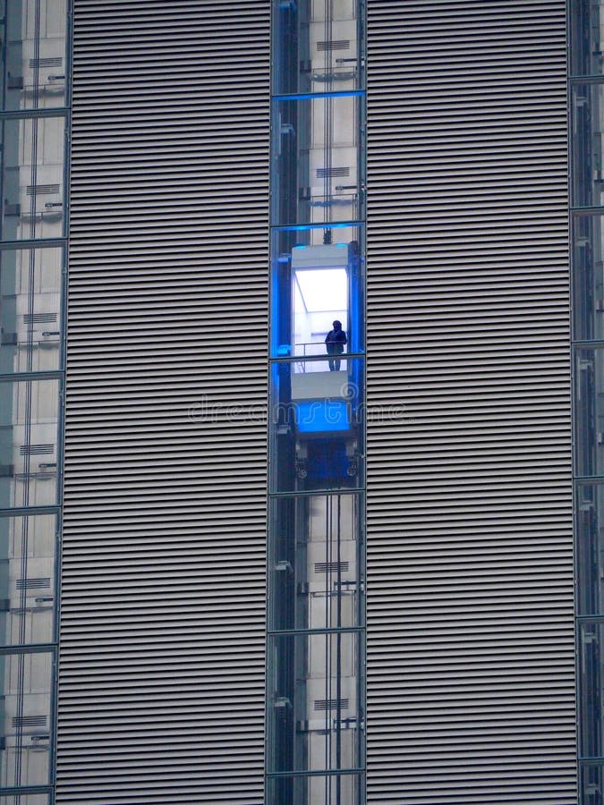 Skyscraper External Elevator with Persons Silhouette Inside Stock Image ...