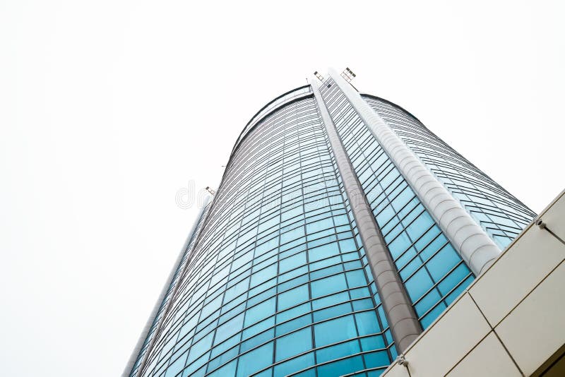 Skyscraper Facade with Blue Windows on White Rain Clouds Background ...