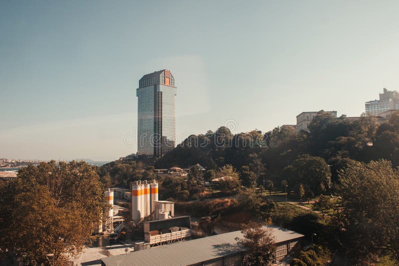 Skyscraper and Factory, Surrounded by Green Editorial Image - Image of ...