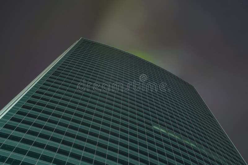 Skyscraper in Fog with Glowing Windows at Night Stock Photo - Image of ...