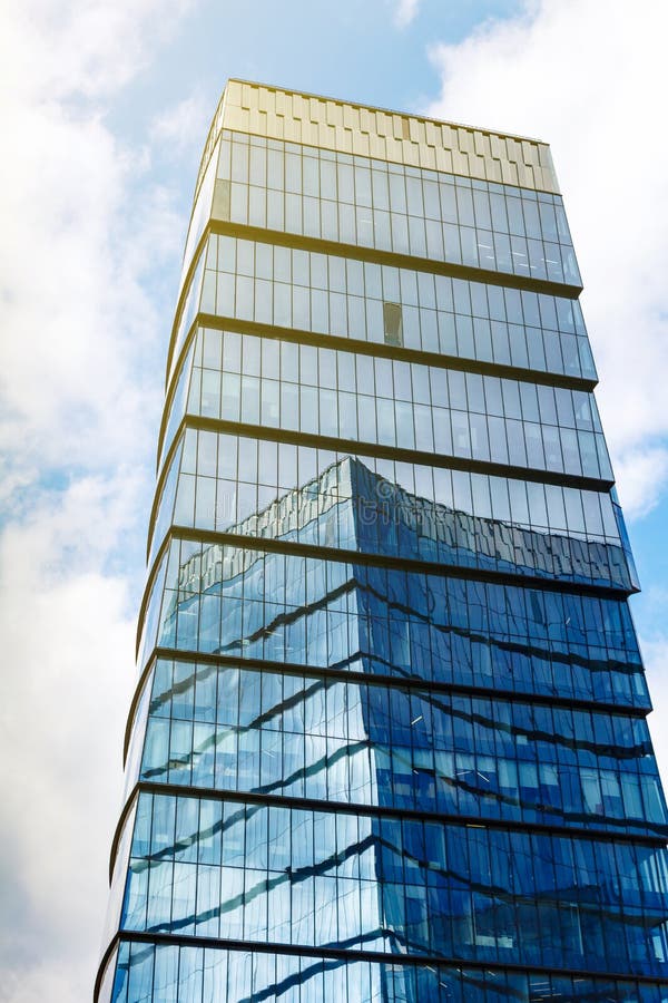 Skyscraper with a Glass Facade Against a Blue Sky Background Stock ...