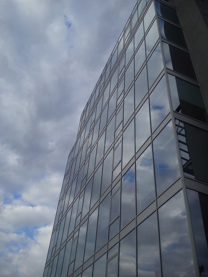 Skyscraper with Glass Walls and Windows. the Glass Reflects the Blue ...