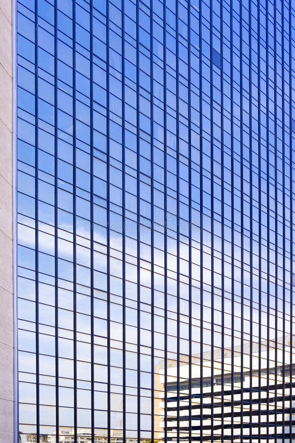 Skyscraper with Light Reflection of Blue Sky on Glass Building Wall ...
