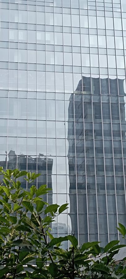 Skyscraper in the Mirror Image of the Glass Building Stock Image ...