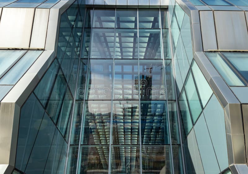 The Skyscraper is Reflected in the Windows of the Facade of a Modern ...