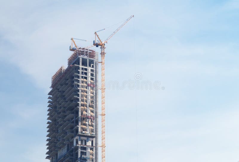 Skyscraper Under Construction with Crane on Blue Sky Background Stock ...