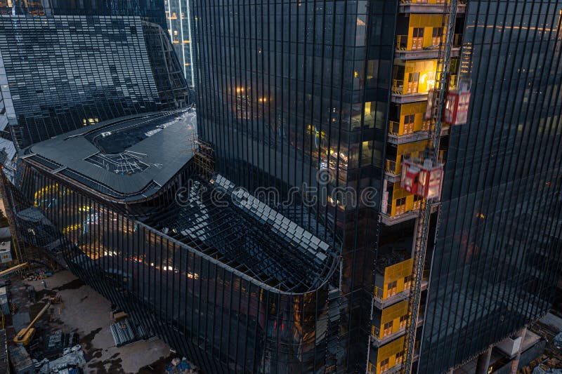 Skyscraper Under Construction in the Evening, Decorated with Glass ...
