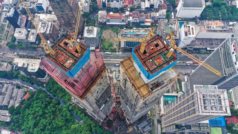 Skyscraper Under Construction in Jakarta City. Top Down Cranes on the ...