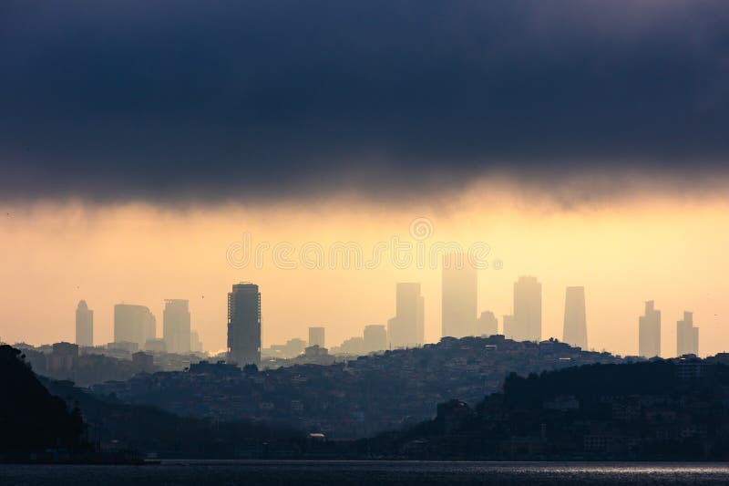 Skyscrapers and Hills at Sunset with Partly Cloudy Sky Stock Photo ...