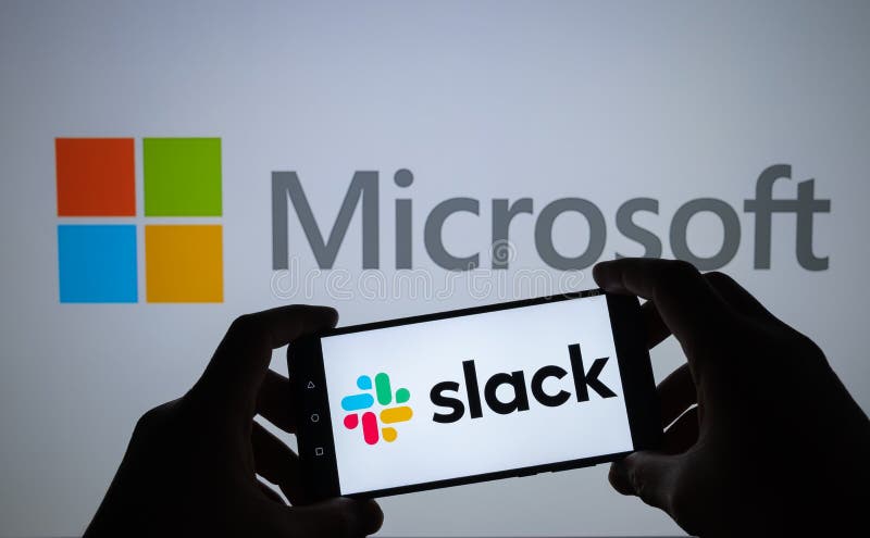 Slack Logo Seen on Smartphone Silhouette in Hands and Microsoft Logo on ...