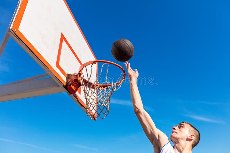 Slam Dunk. Side View of Young Basketball Player Making Slam Dunk Stock ...