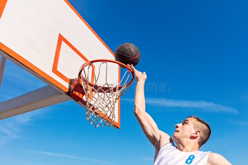 Slam Dunk. Side View of Young Basketball Player Making Slam Dunk Stock ...