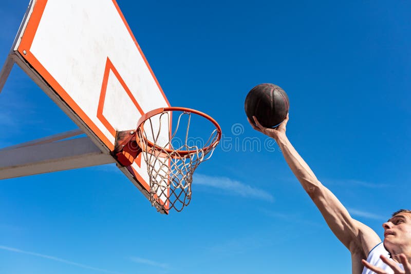 Slam Dunk. Side View of Young Basketball Player Making Slam Dunk Stock ...
