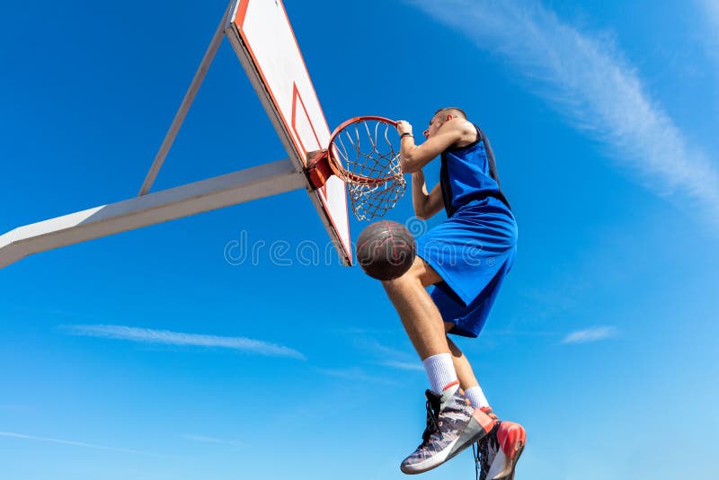 Slam Dunk. Side View of Young Basketball Player Making Slam Dunk Stock ...