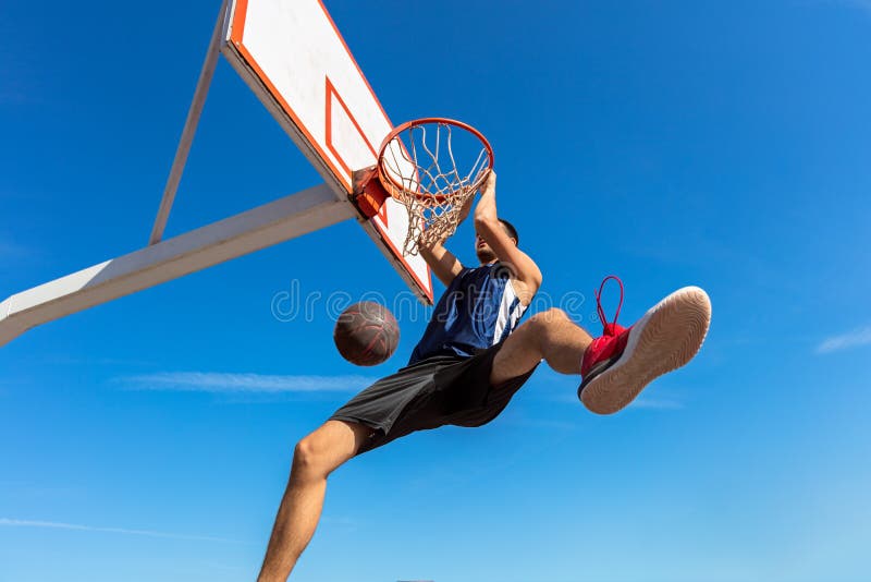 Slam Dunk. Side View of Young Basketball Player Making Slam Dunk Stock ...