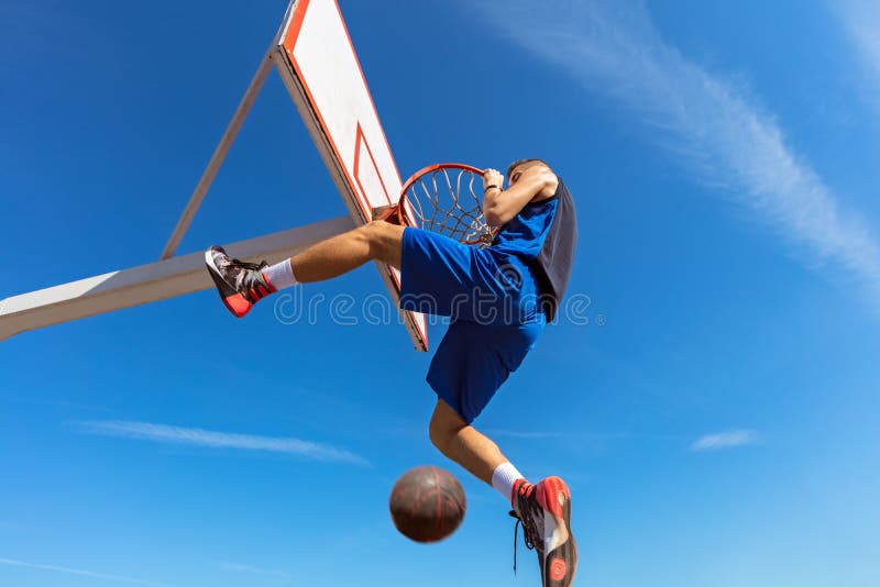 Slam Dunk. Side View of Young Basketball Player Making Slam Dunk Stock ...