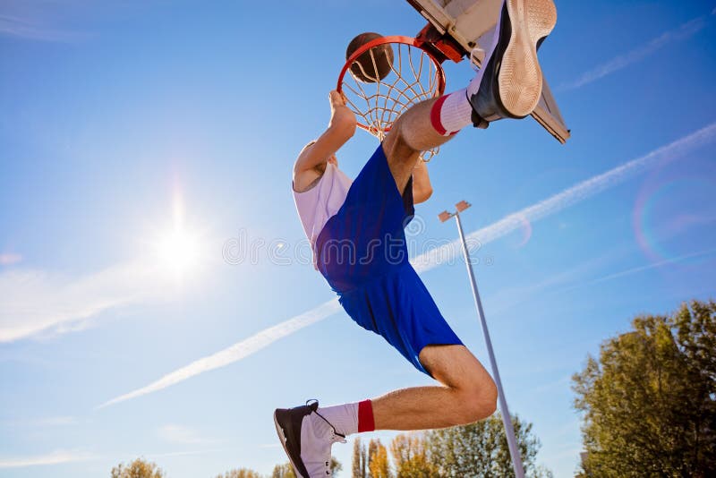 Slam Dunk. Side View of Young Basketball Player Making Slam Dunk Stock ...