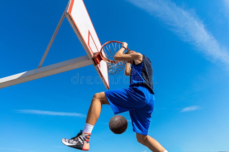 Slam Dunk. Side View of Young Basketball Player Making Slam Dunk Stock ...