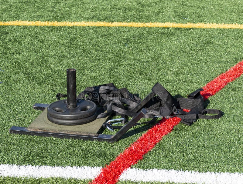 A Sled with Weights on a Turf Field for Speed, Strength and Agility ...