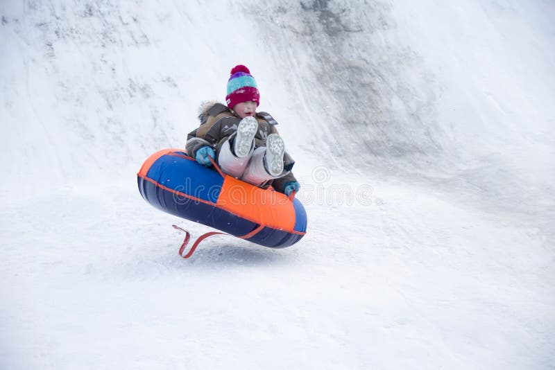 Sledding off a snow slide stock image. Image of riding - 167576221