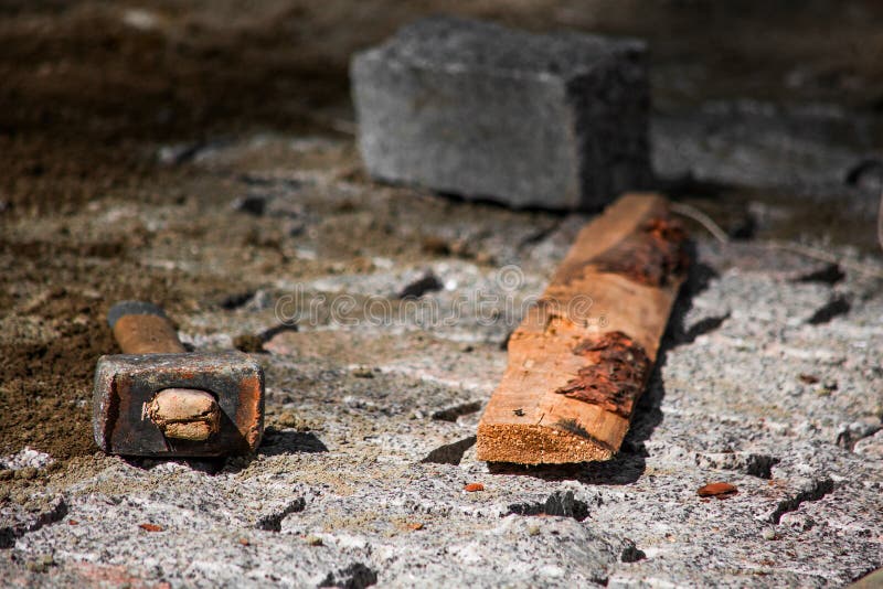 A Sledgehammer with a Board Lay on the Paving Under Construction Stock ...