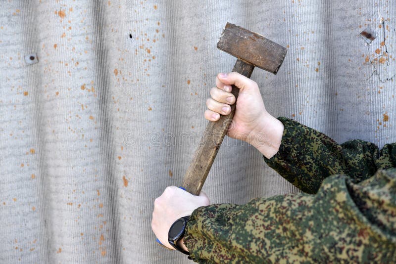 A Sledgehammer in the Hands of a Man. a Large Hammer in His Hands Stock ...