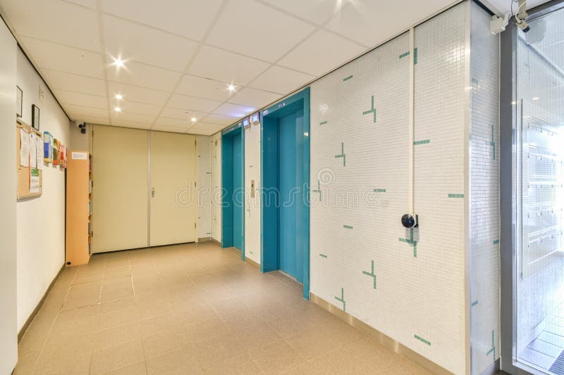 Modern Hallway with Blue Elevators Stock Image - Image of inviting ...