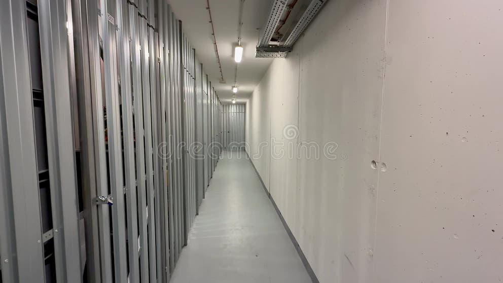 A Spacious and Long Corridor Featuring Multiple Storage Units in a ...
