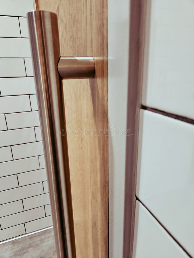 Sleek Modern Door Design with Long Metal Handle and Subway Tile Wall ...