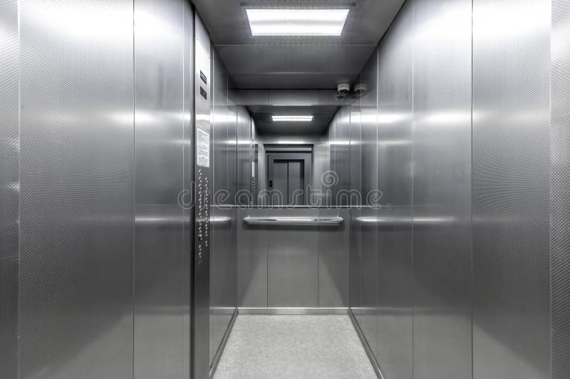 Sleek Steel Elevator Cabin with Mirror Stock Image - Image of grip ...