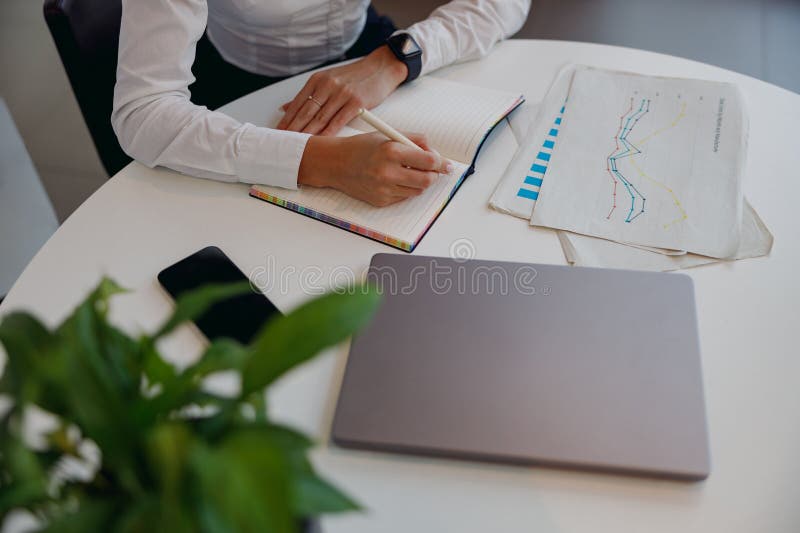 A Professional Workspace Featuring a Laptop and Wellorganized Notes for ...