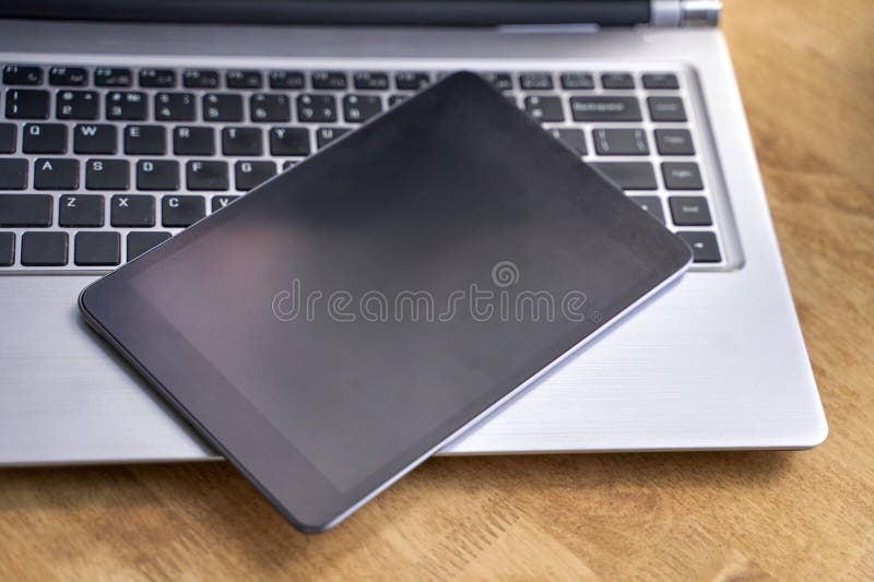 Sleek Tablet Resting on Laptop Keyboard: Modern Technology and Mobile ...